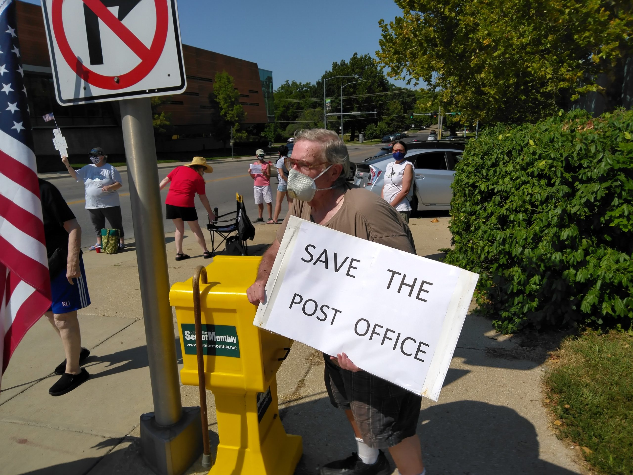 Protesters gather at downtown Lawrence post office to decry Postmaster ...